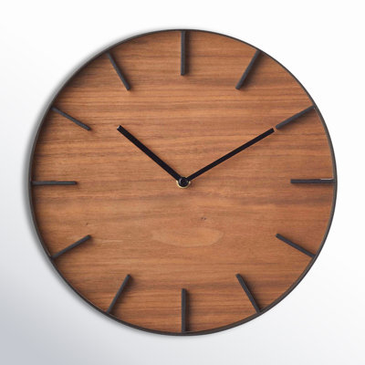 wall clock on brown wall