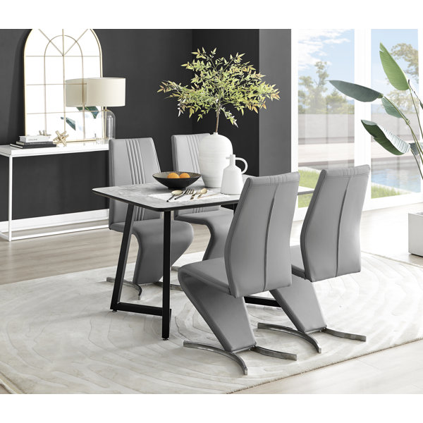 East Urban Home Carzon Marble Effect Melamine Dining Table and Chairs ...