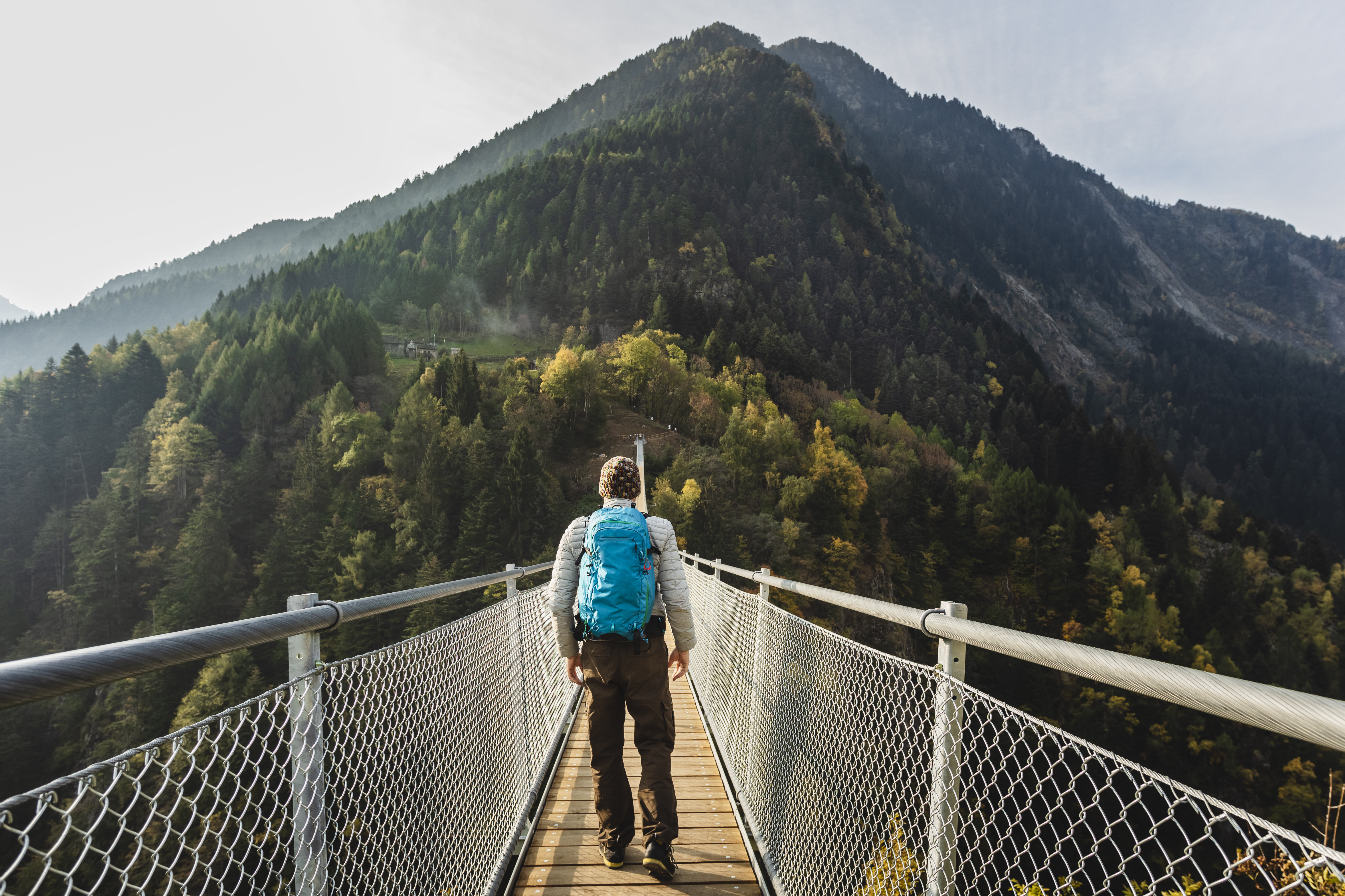 Millwood Pines Solo Hiker Walking on Suspension Bridge Between Two ...