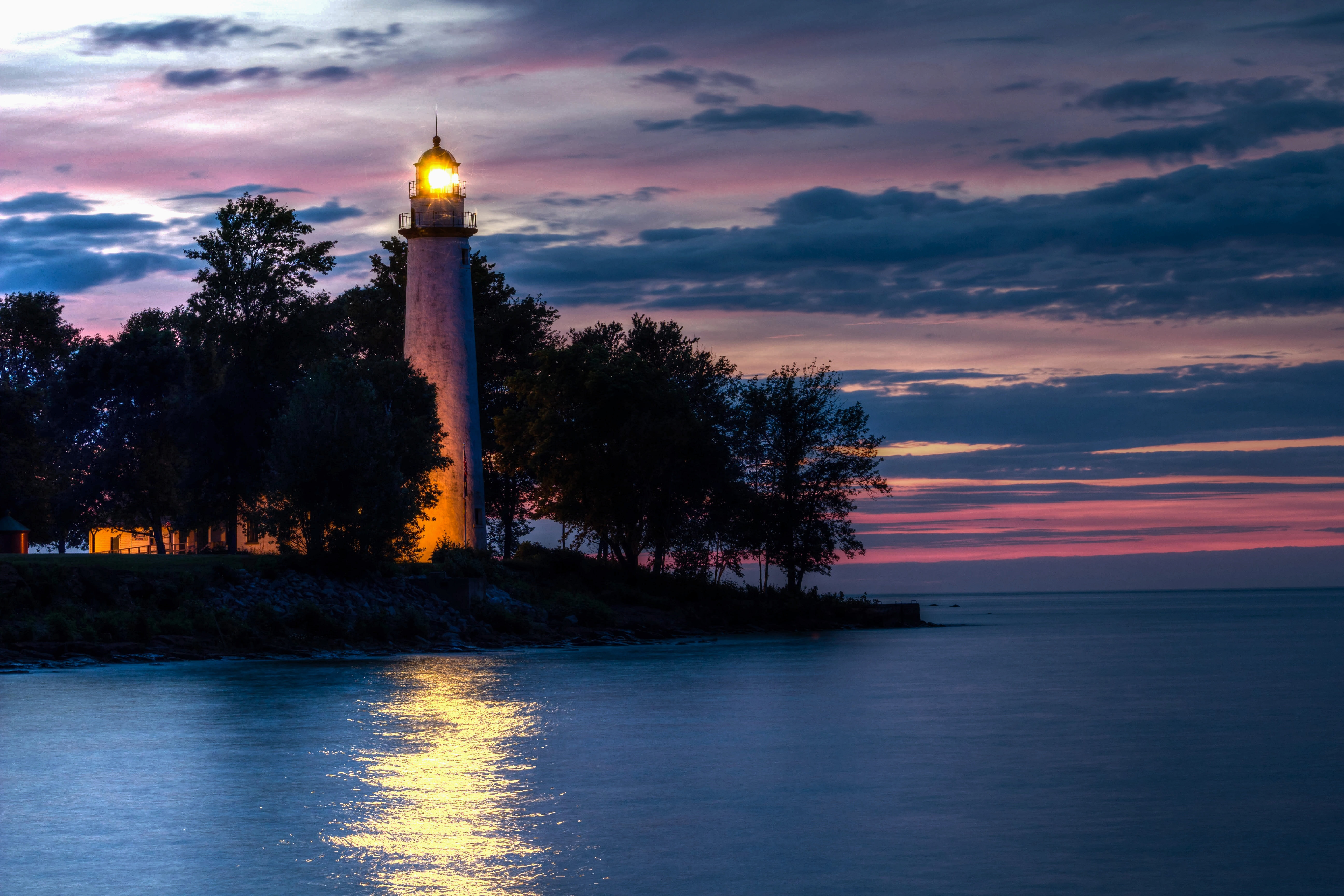 Breakwater Bay Lighthouse Glowing by Ehrlif - Wrapped Canvas Photograph ...