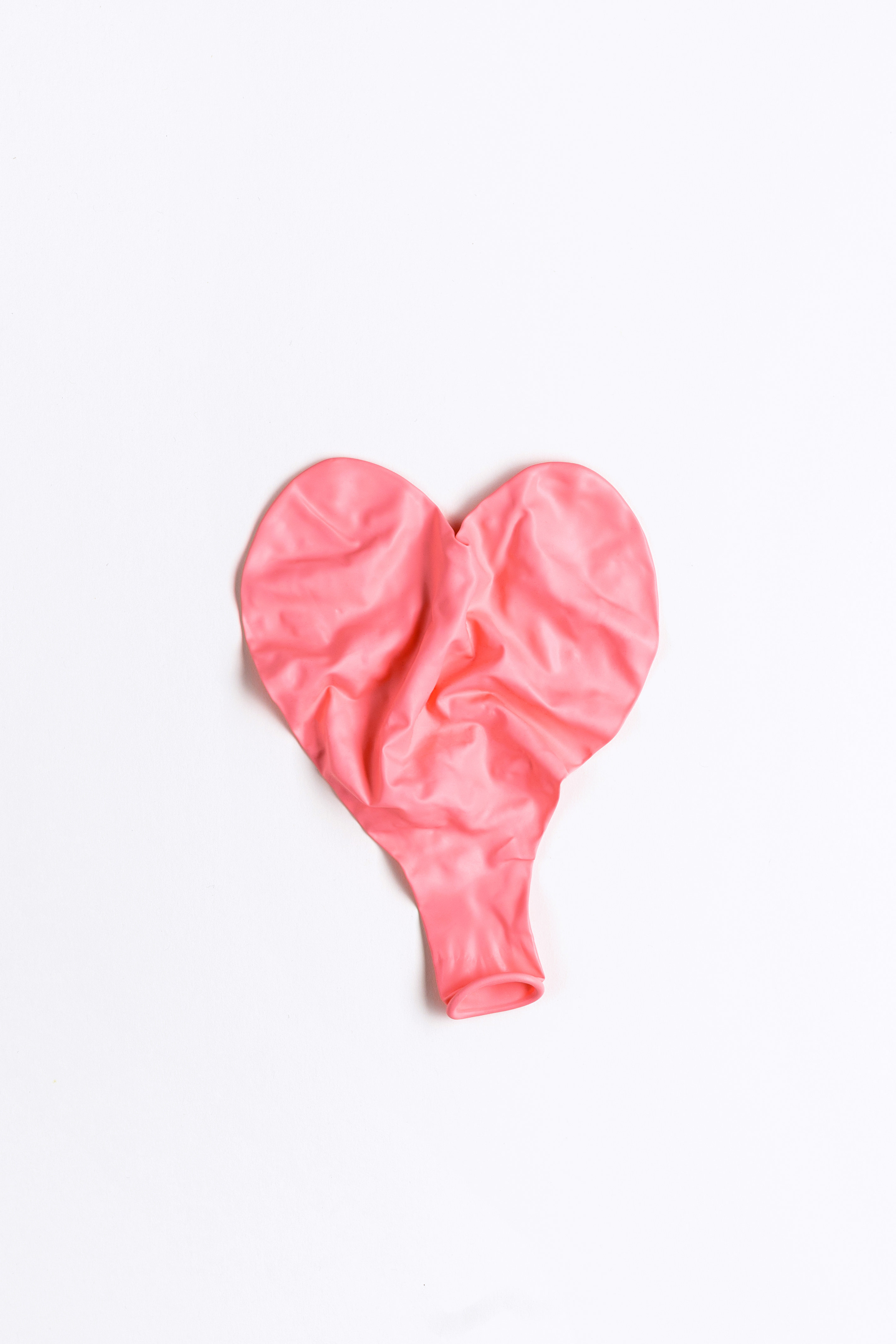 Ebern Designs Deflated Wrinkled Pink Heart Shaped Balloon Laying Flat ...