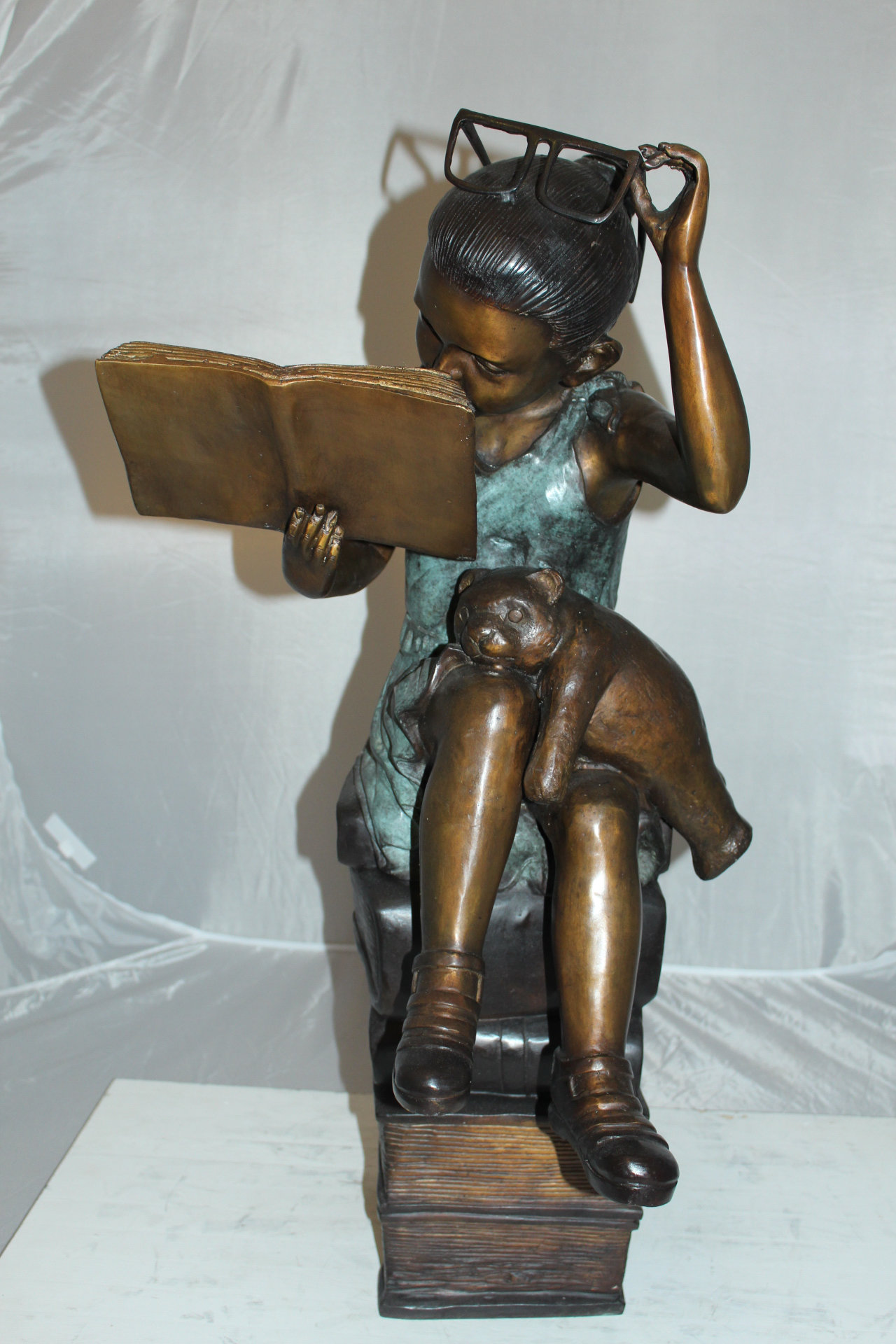 Bloomsbury Market Bieber Girl Sitting On Stack of Books Reading a Book ...