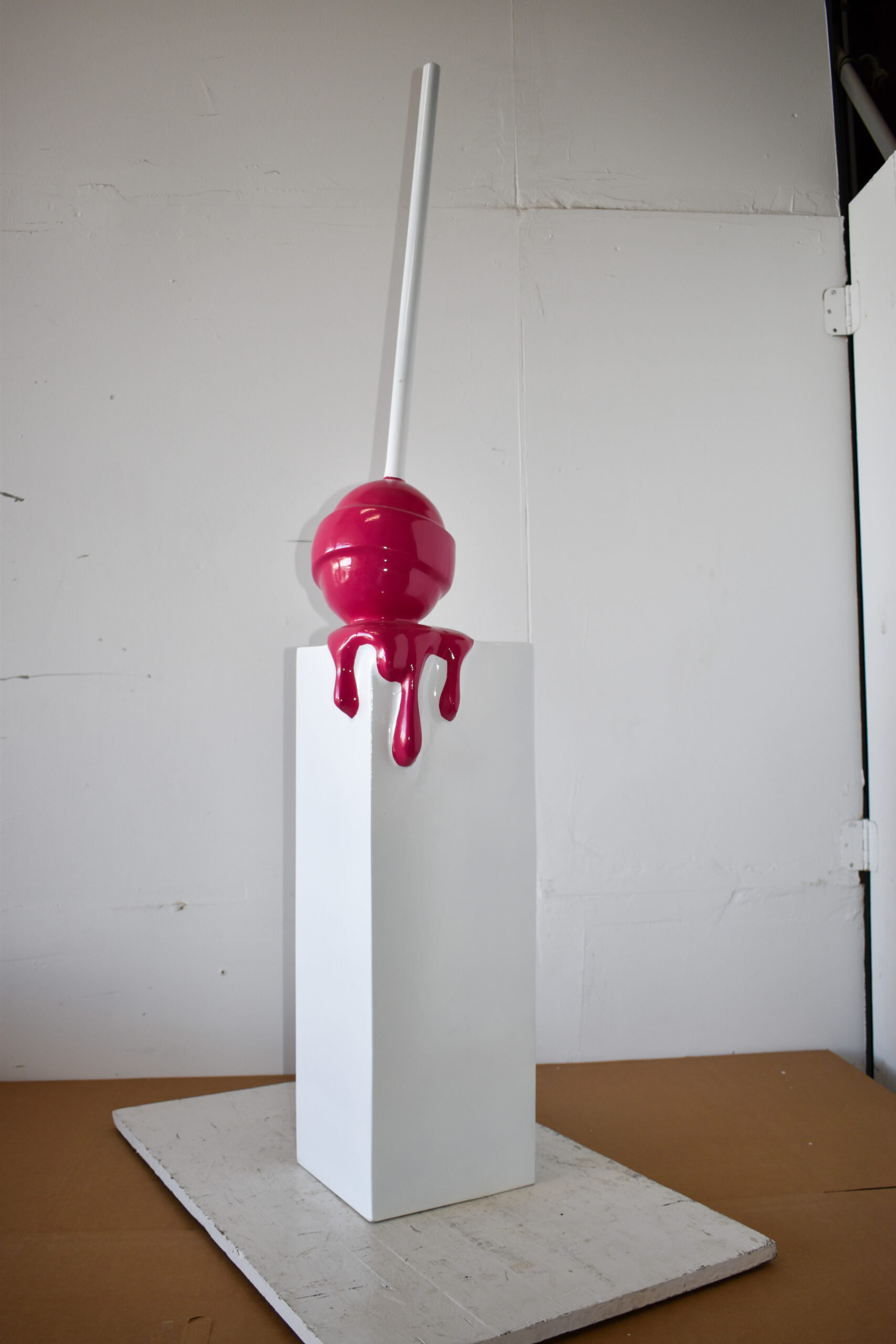 NIFAO Red Lollipop Mounted on A White Pedestal Resin Statue Size: 10" x ...