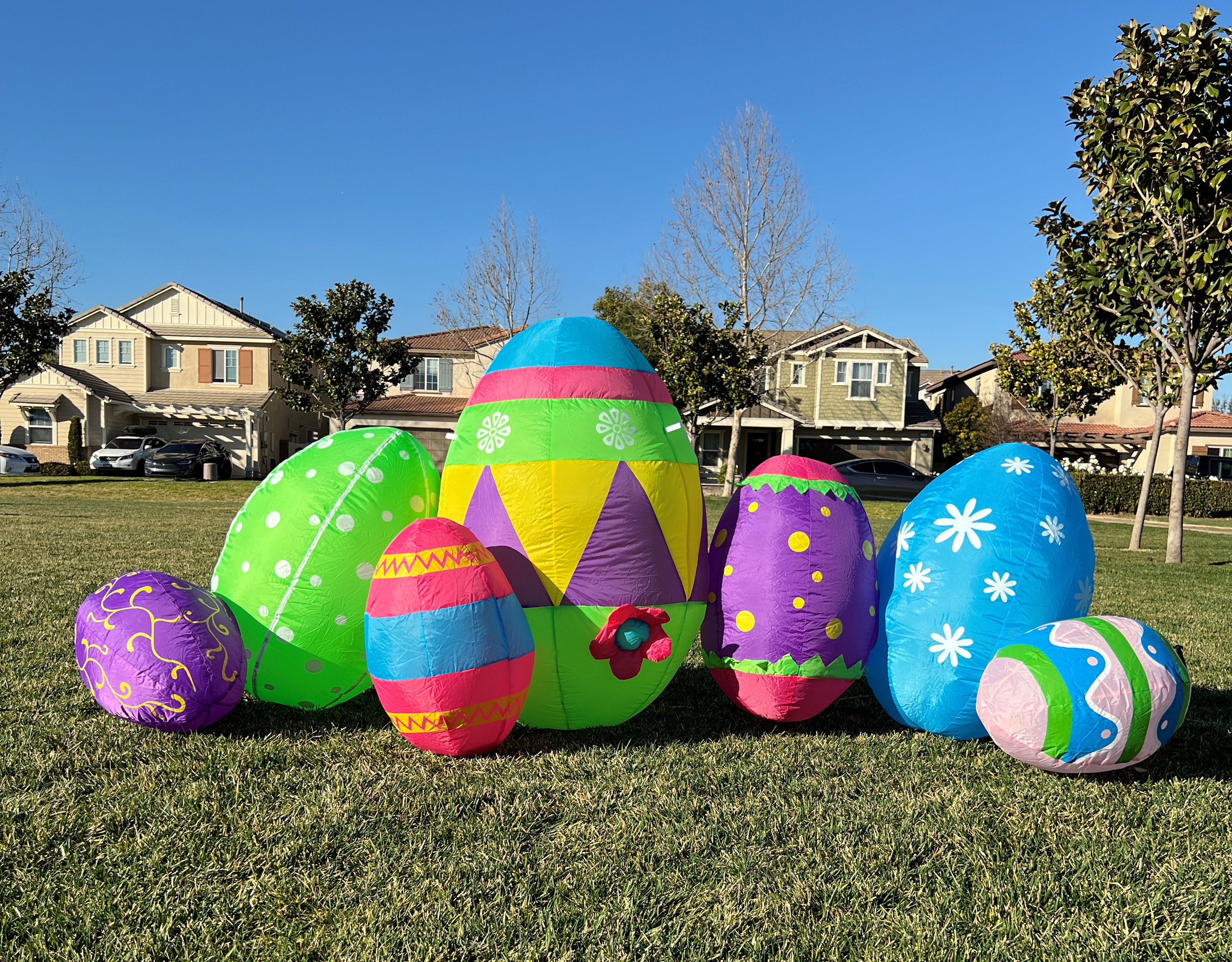 The Holiday Aisle® 8 Foot Long Happy Easter Lighted Inflatable Seven Colorful Easter Eggs Patch ...